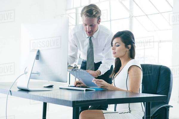 Business people working on computer by office window - Stock Photo ...