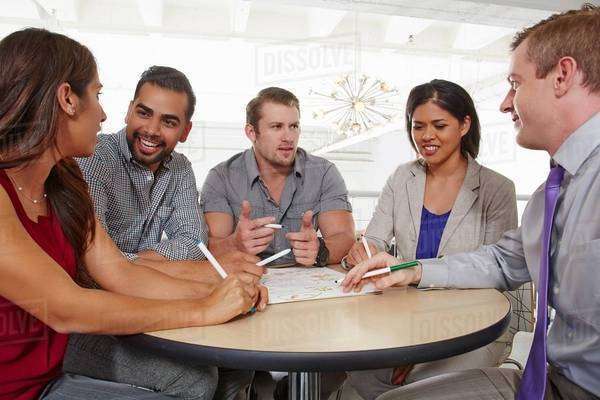 Small group of people having brainstorming business meeting - Royalty ...