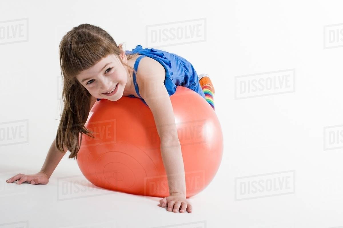 A girl lying on a ball - Royalty-free Stock Photo | Dissolve