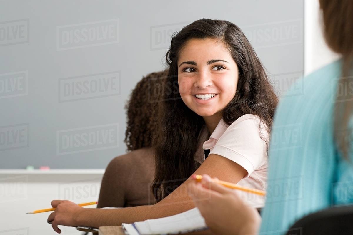 Girl smiling in class - Royalty-free Stock Photo | Dissolve