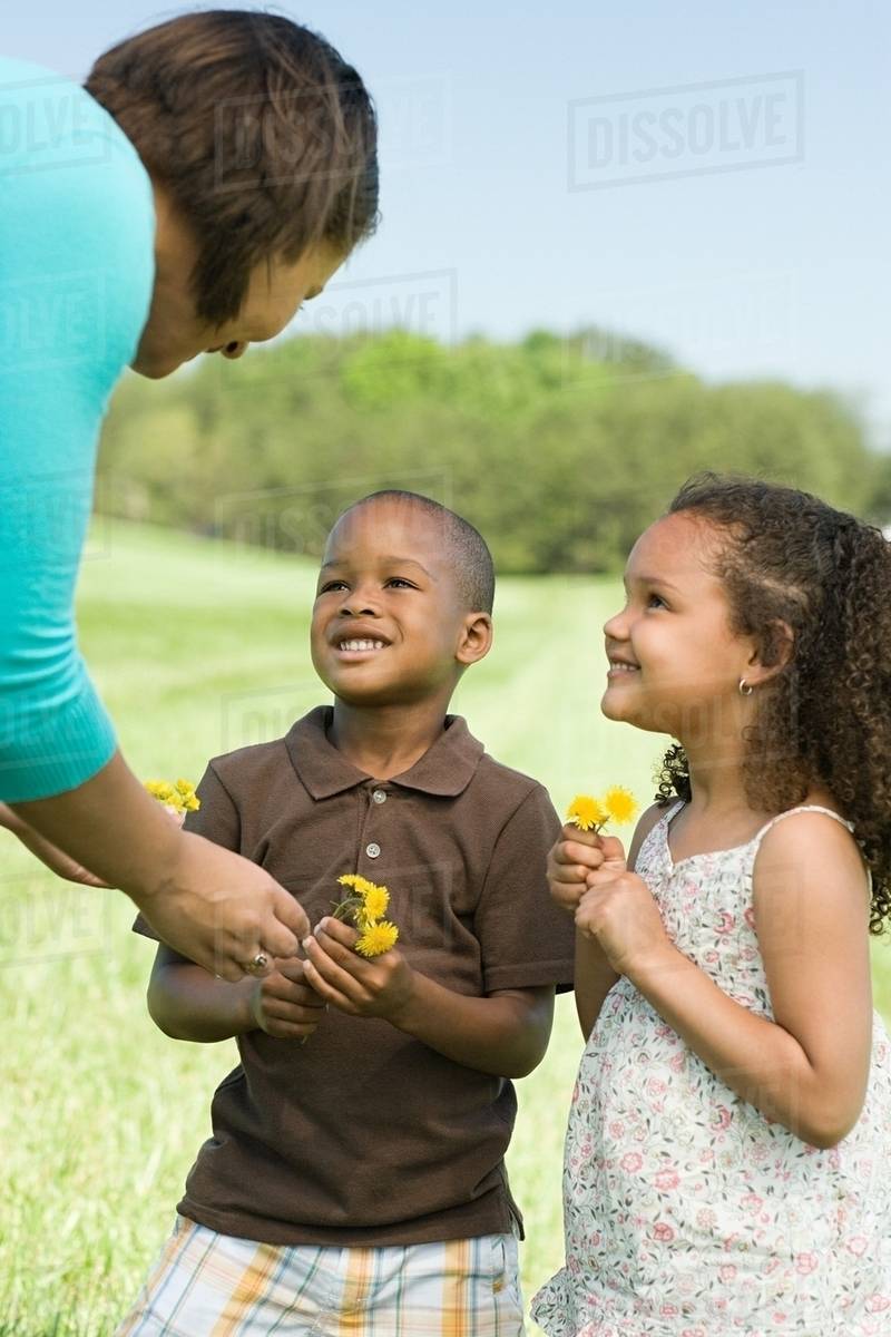 Mother and children with flowers - Royalty-free Stock Photo | Dissolve