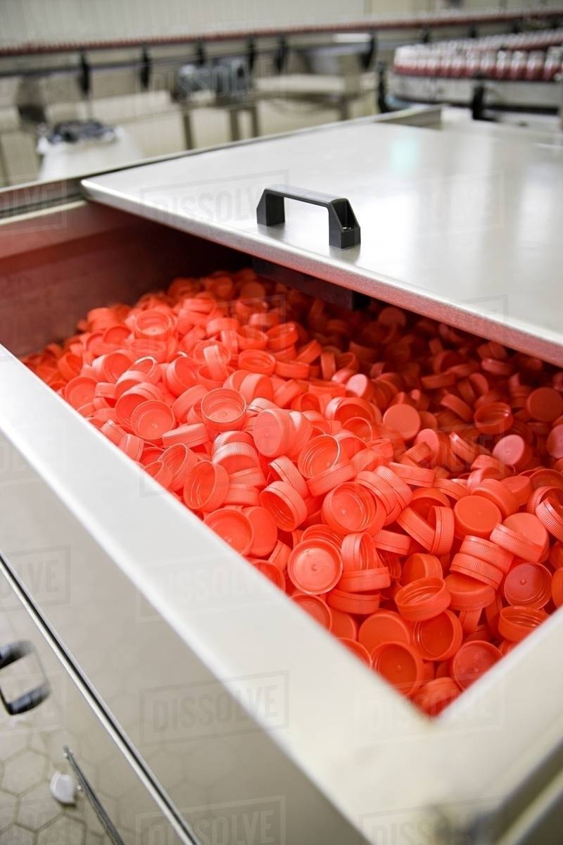 Red lids in a factory - Royalty-free Stock Photo | Dissolve