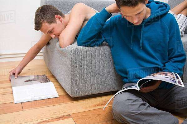Two men reading magazines - Royalty-free Stock Photo | Dissolve