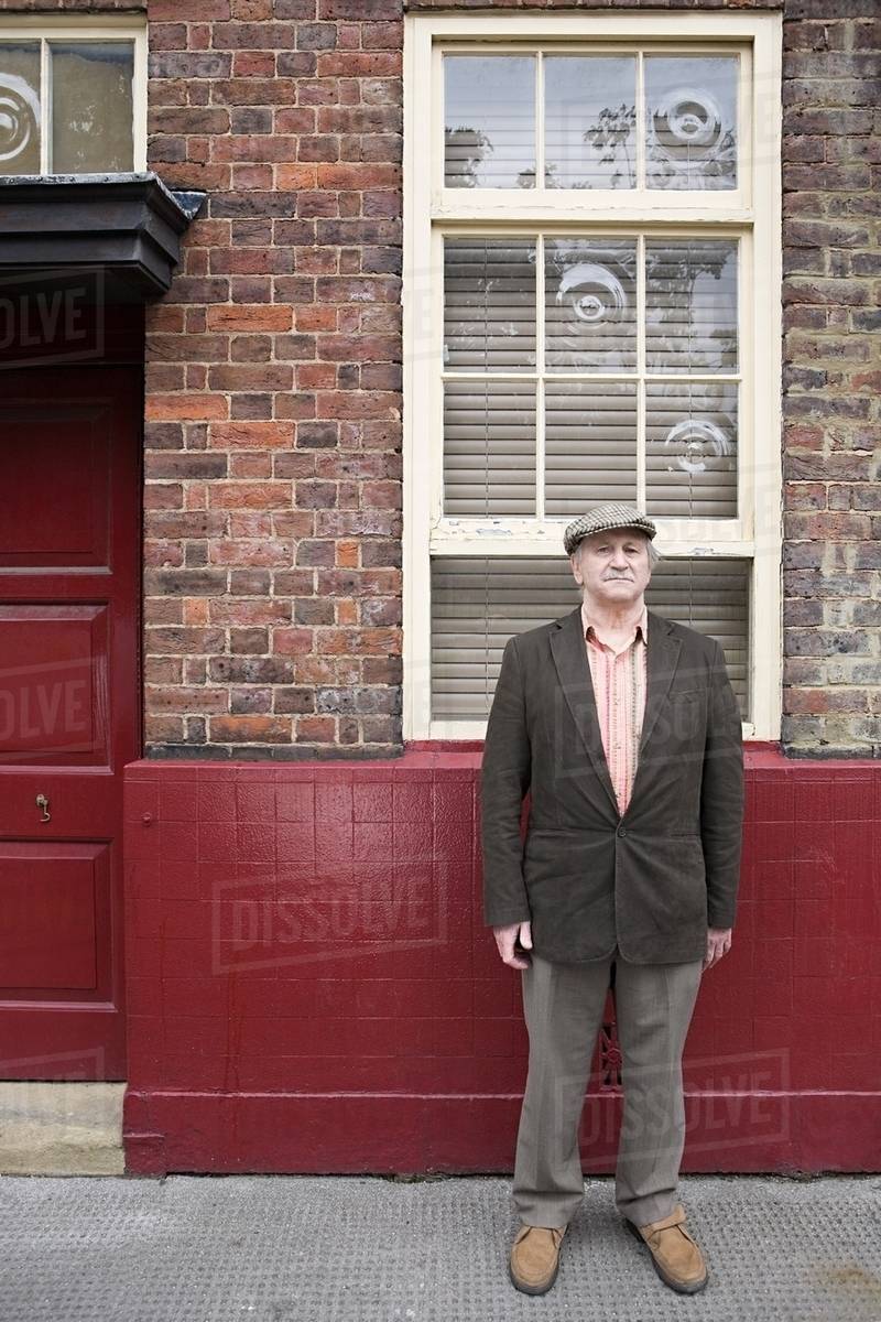 Senior man outside building - Stock Photo - Dissolve