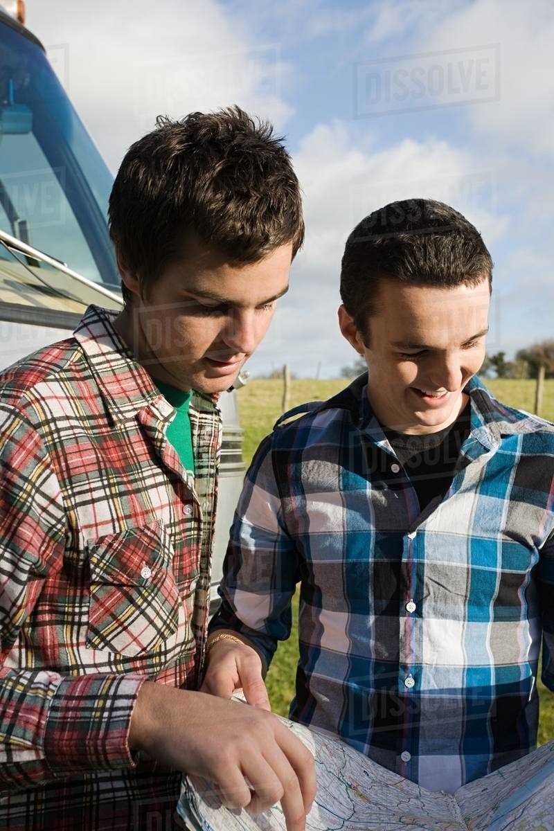 Teenage boys looking at a map - Royalty-free Stock Photo | Dissolve