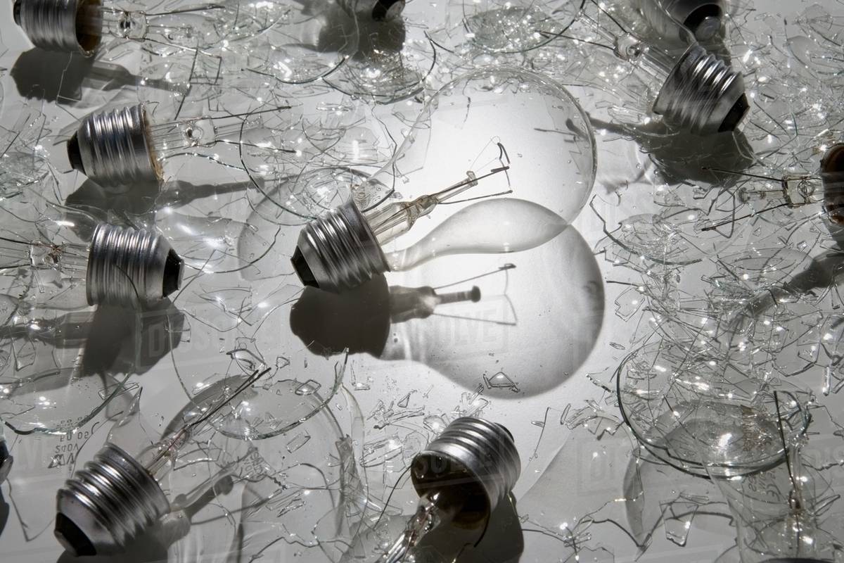 Lightbulb surrounded by broken bulbs - Royalty-free Stock Photo | Dissolve