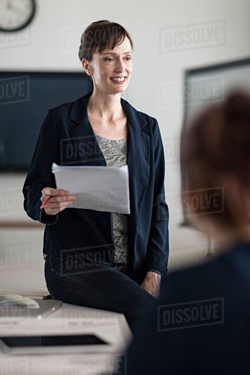 Woman presenting in meeting - Royalty-free Stock Photo | Dissolve