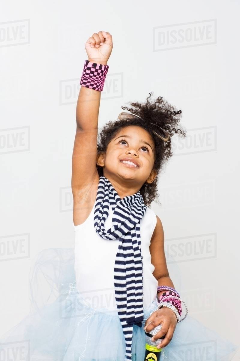 Portrait of a girl raising her arm - Stock Photo - Dissolve