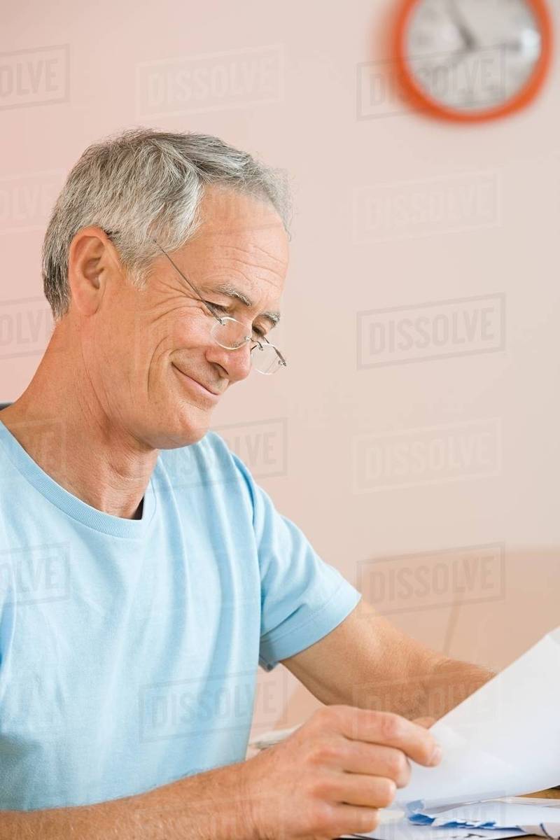 A man reading a letter - Stock Photo - Dissolve