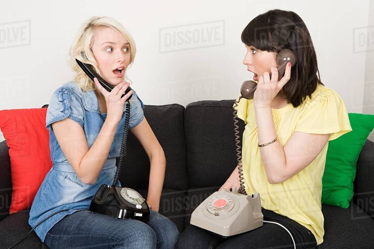 Two women having telephone conversations - Stock Photo - Dissolve