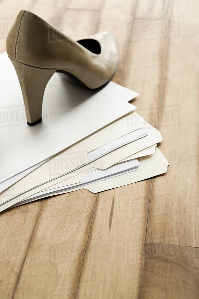 Files and a high heeled shoe on a wooden floor - Royalty-free Stock ...