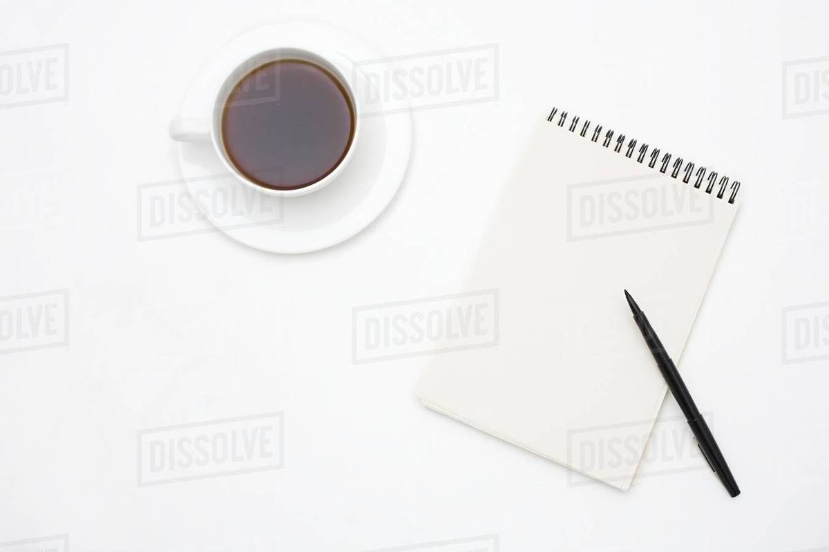 Notepad and coffee cup - Stock Photo - Dissolve