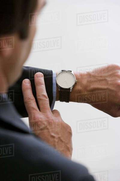 A businessman looking at his watch - Royalty-free Stock Photo | Dissolve