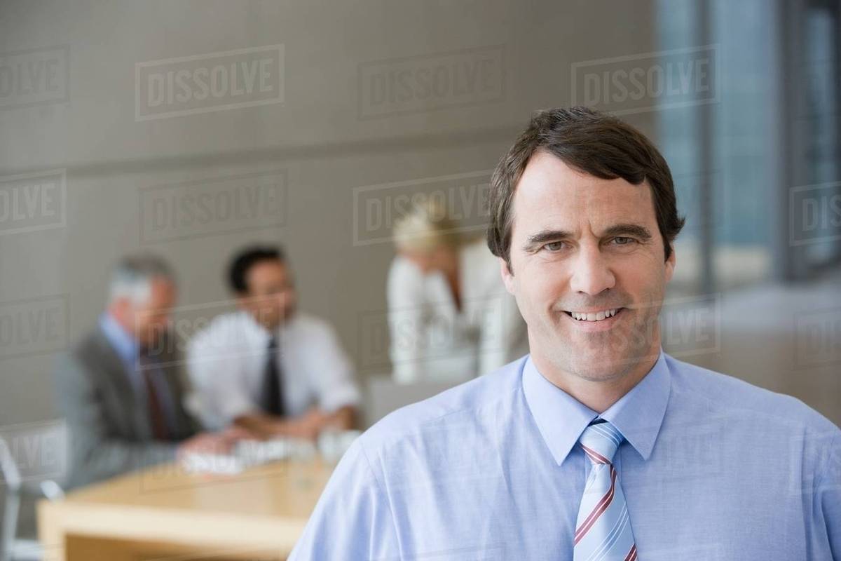 Smiling male office worker - Royalty-free Stock Photo | Dissolve