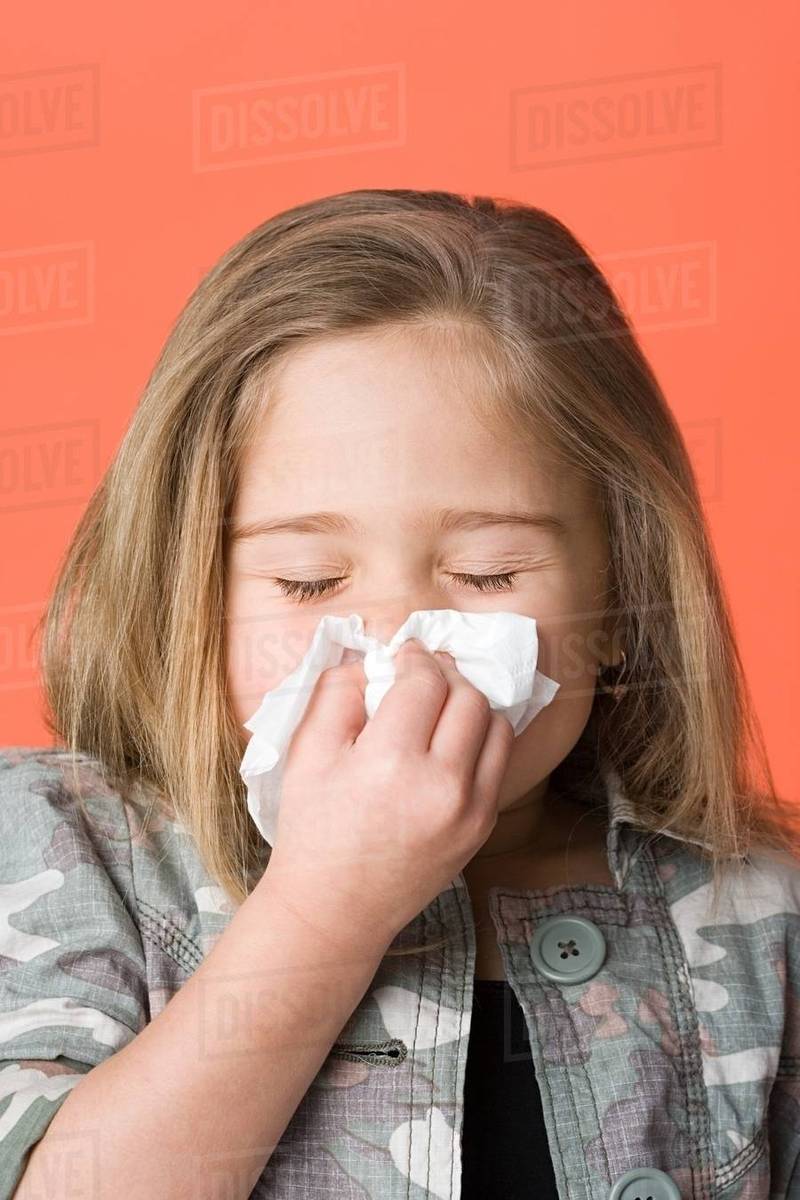 Girl sneezing - Royalty-free Stock Photo | Dissolve