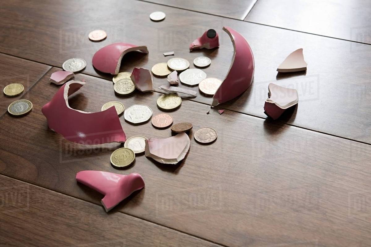 A smashed piggy bank - Stock Photo - Dissolve