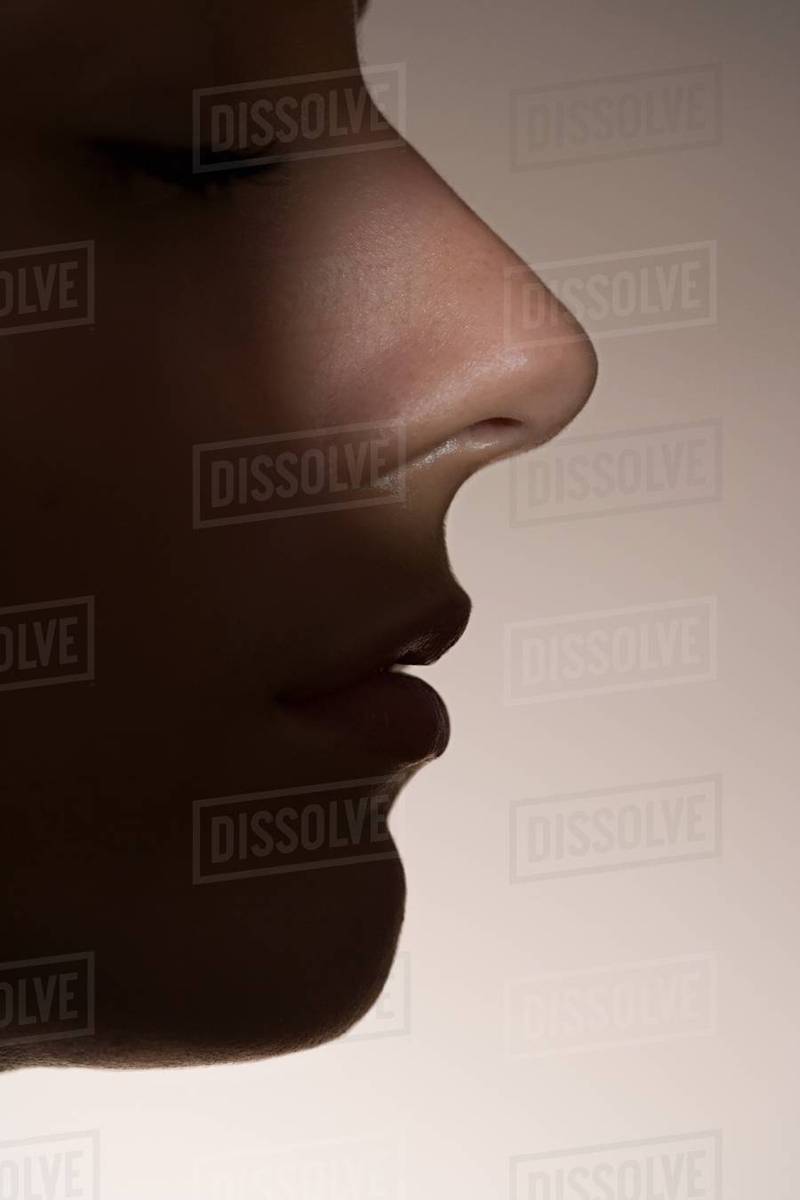 A womans nose illuminated - Stock Photo - Dissolve