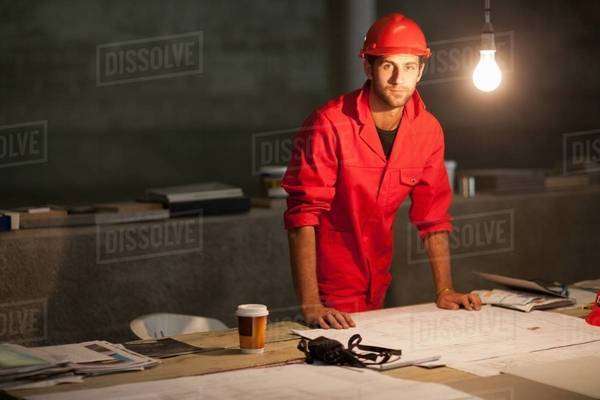 Building contractor working late on site - Stock Photo - Dissolve