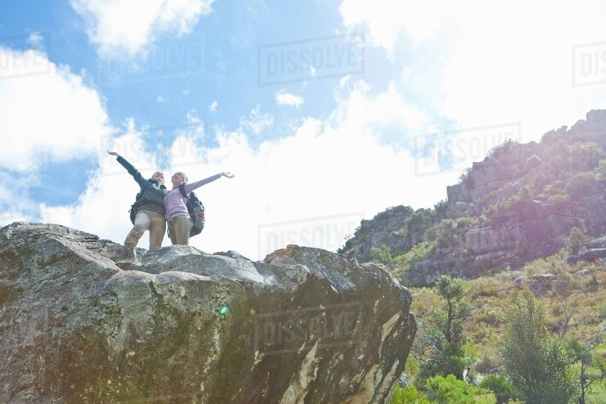 Two girl hikers celebrating on top of rock formation - Stock Photo ...