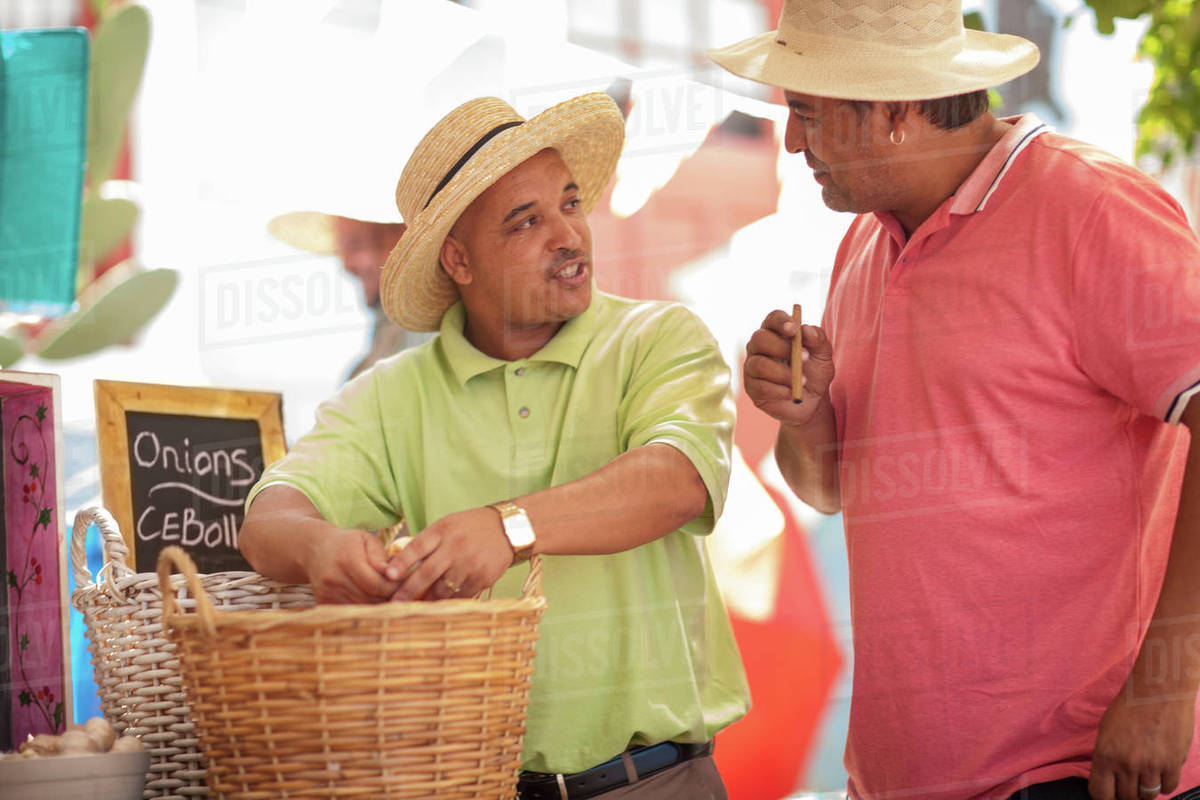Market traders chatting - Royalty-free Stock Photo | Dissolve