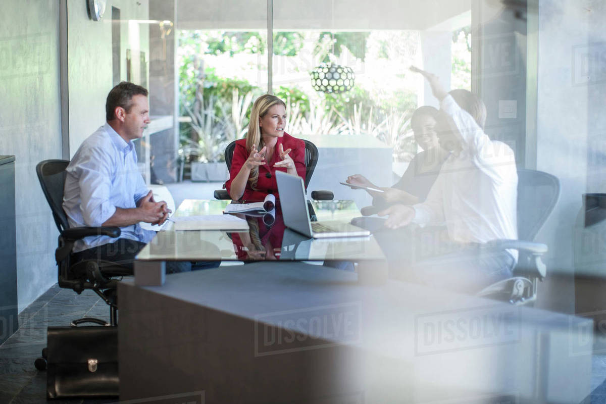 Designer team meeting at conference table in design office - Royalty ...