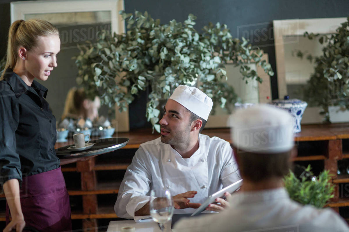 Waitress serving coffee to chefs at break time - Royalty-free Stock ...