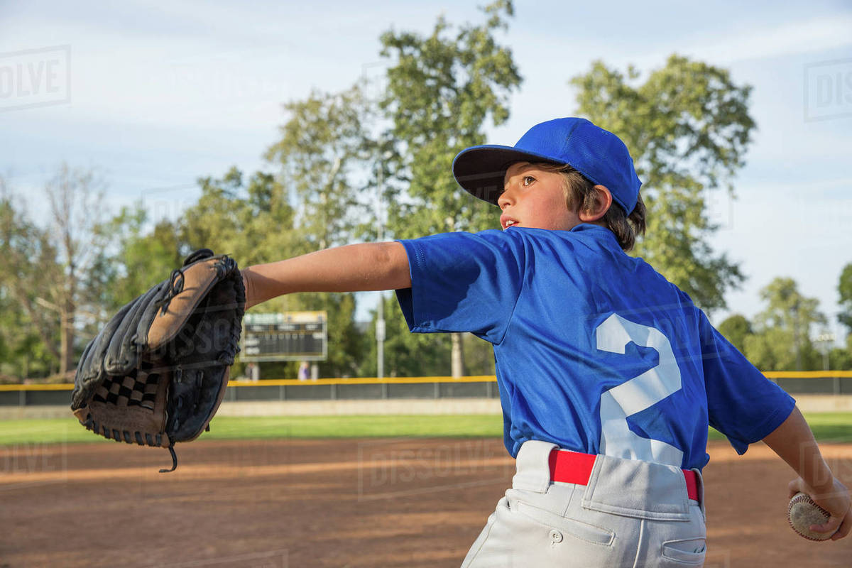 Boy throwing ball at practise on baseball field - Royalty-free Stock ...