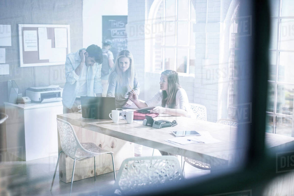 Design team meeting at boardroom table in design studio - Royalty-free ...