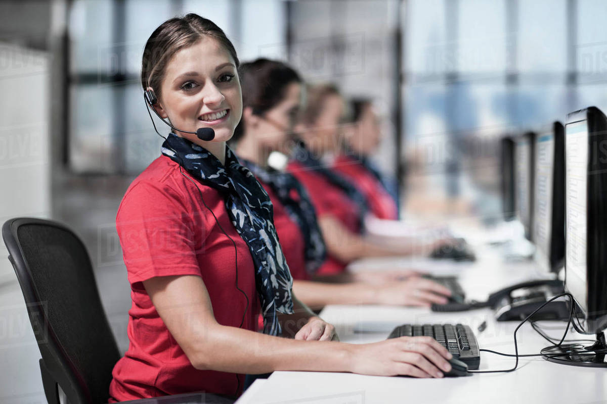 Portrait of female telephonists at work in call centre - Stock Photo ...