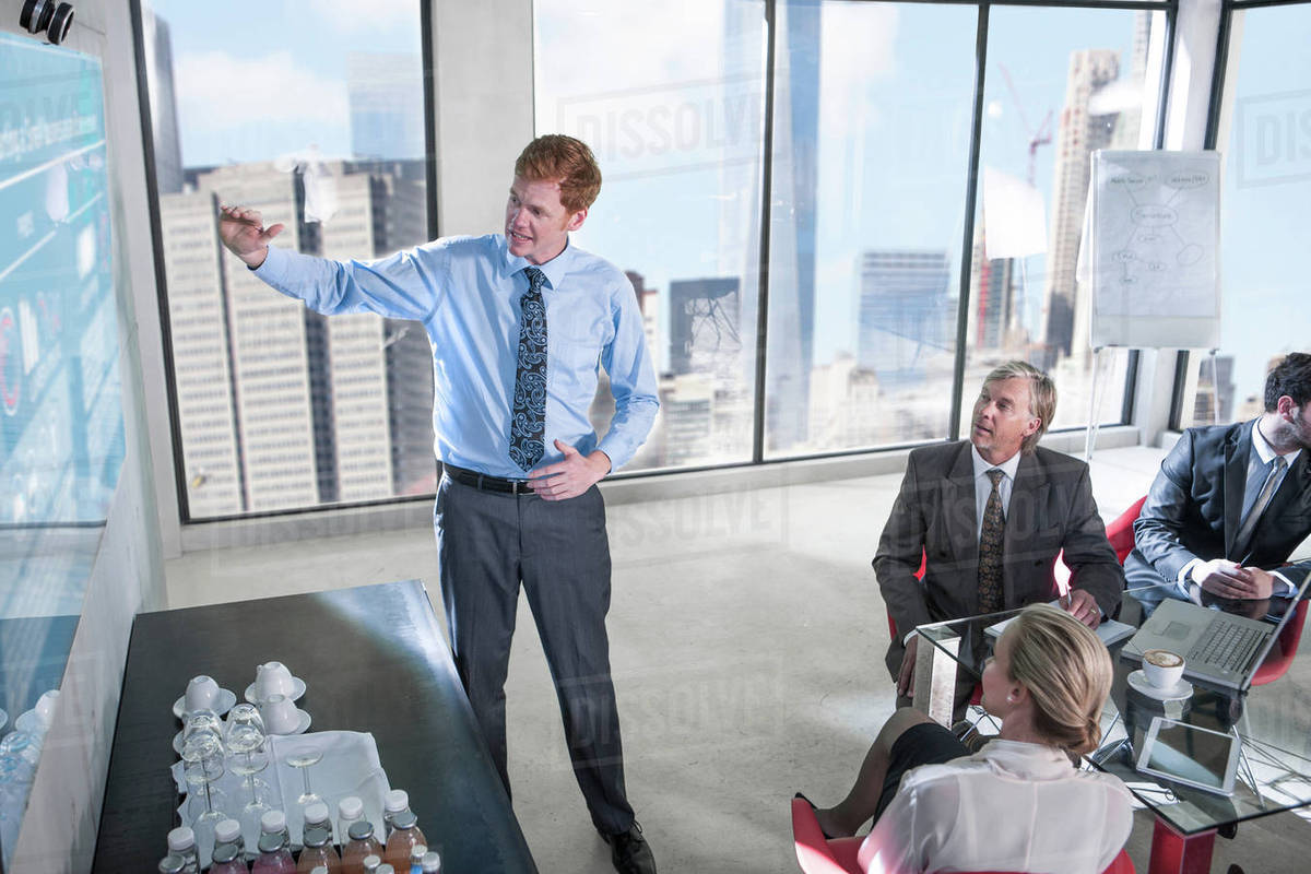 Businessman pointing at screen at presentation, New York, USA - Royalty ...