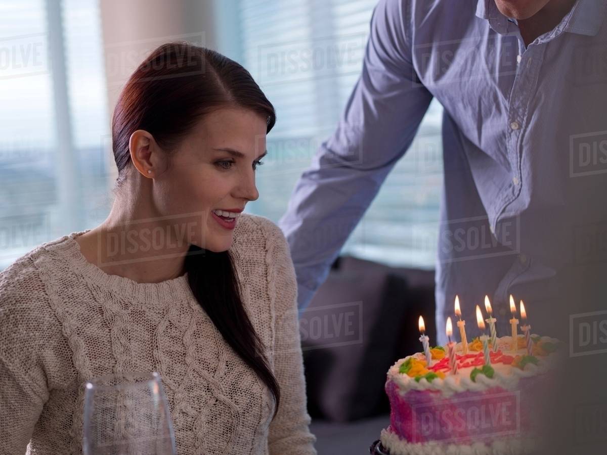 Mid adult man giving young woman birthday cake - Royalty-free Stock ...