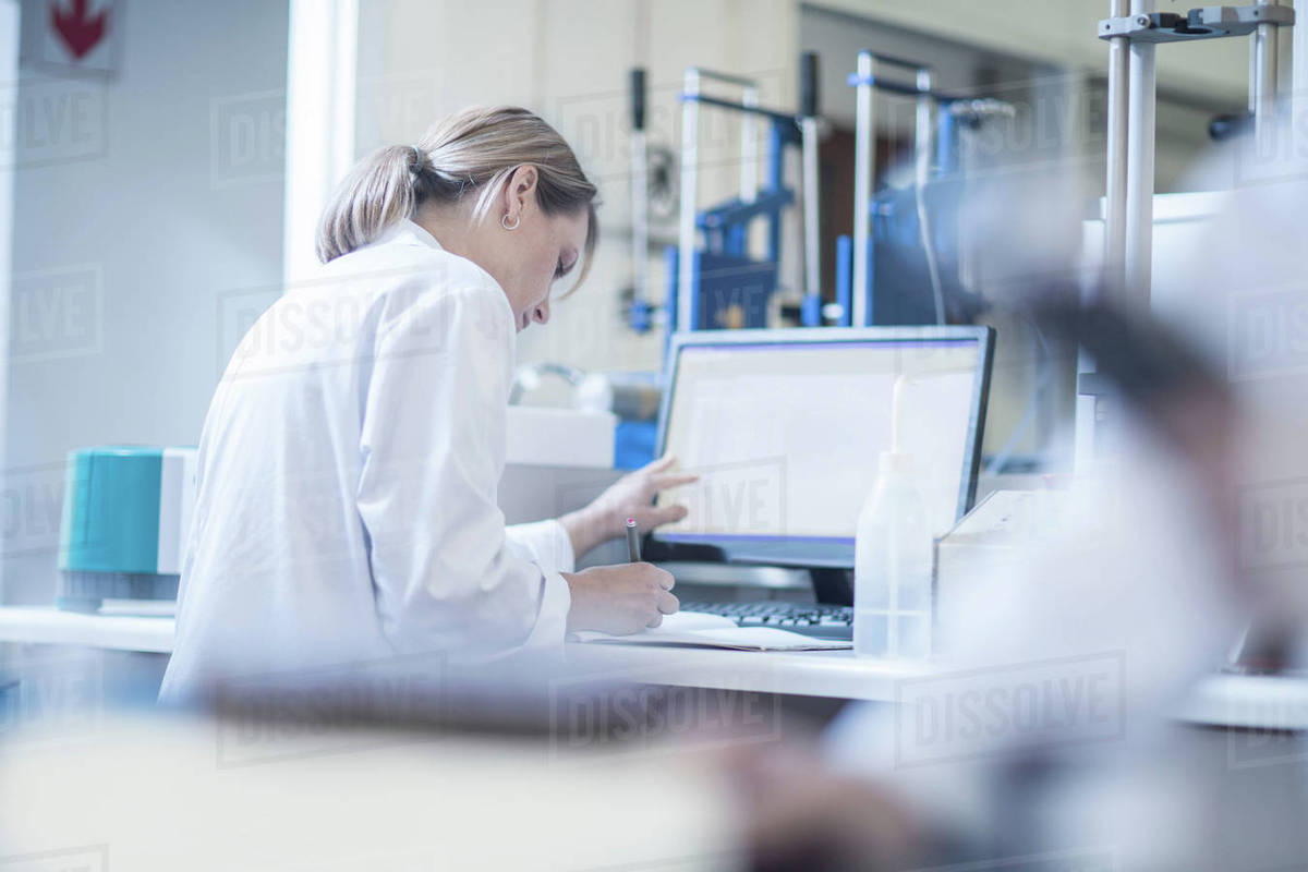 Mid adult woman in laboratory, using computer - Royalty-free Stock ...