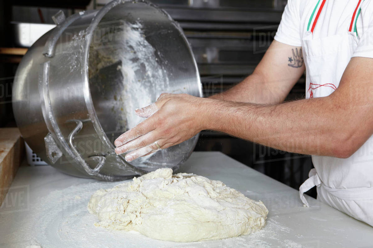 Baker in bakery, making bread - Royalty-free Stock Photo | Dissolve