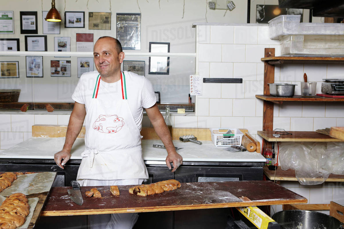Baker working in bakery - Stock Photo - Dissolve