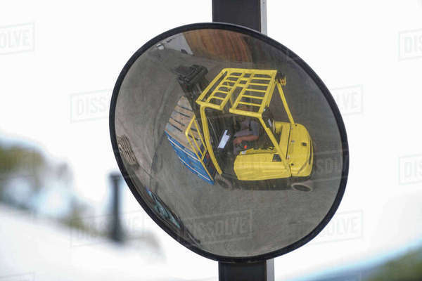 Convex mirror image of forklift driver at packaging factory - Royalty ...