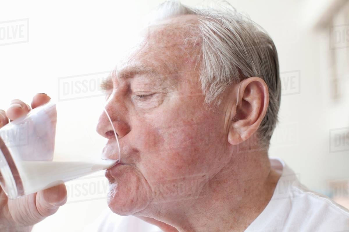 Senior Man Drinking Glass Of Milk Stock Photo Dissolve