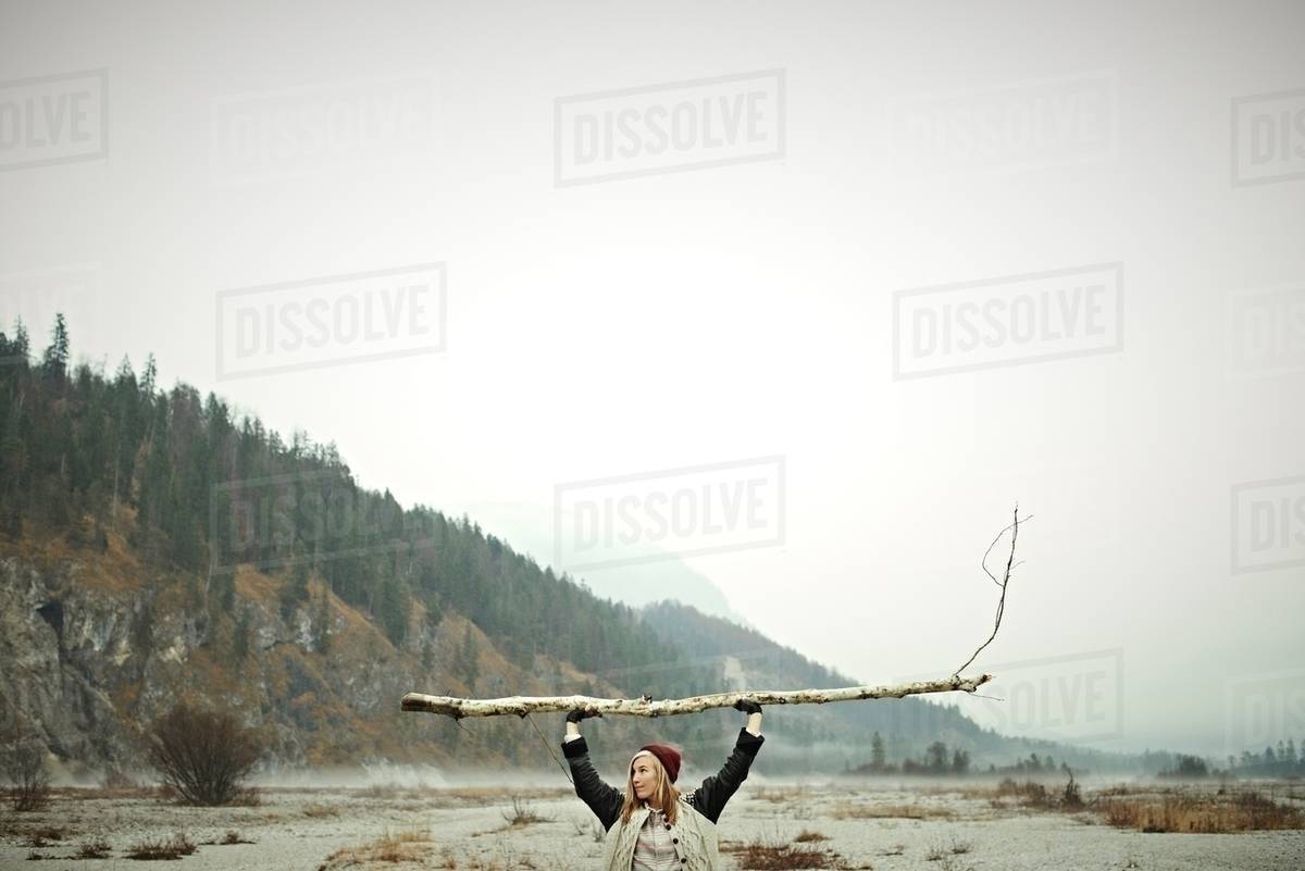Woman holding log - Royalty-free Stock Photo | Dissolve