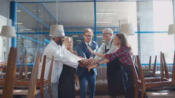 Team Of Happy Diverse Cafe Staff Joining Hands Together Celebrating ...