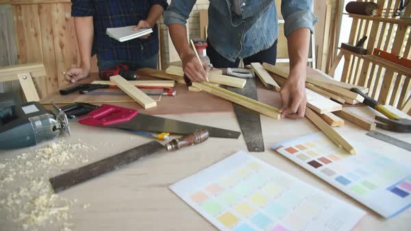 Young Asian group man worker measuring wood plank for build diy wood ...
