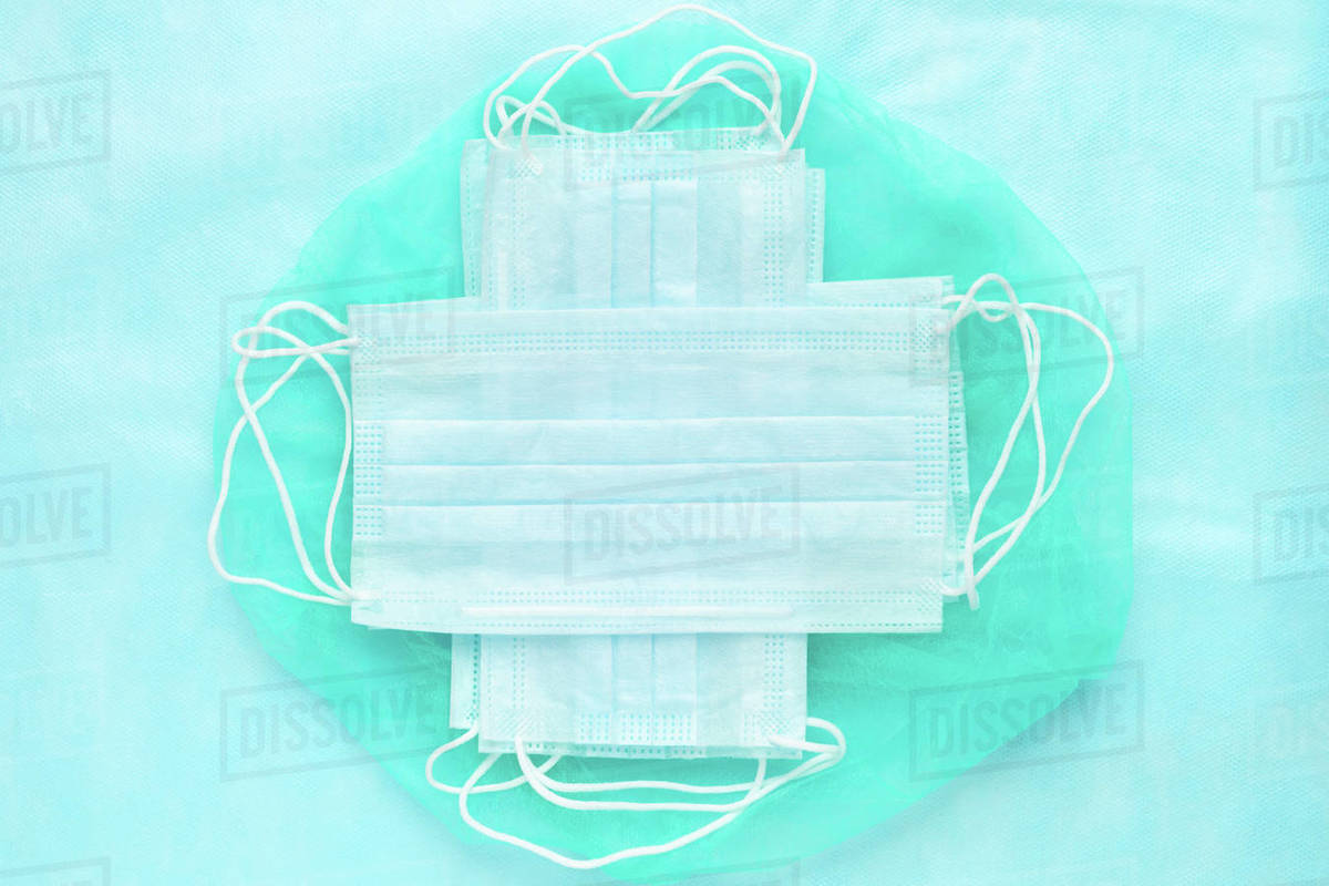Lot medical surgical face masks on green and blue background. World ...