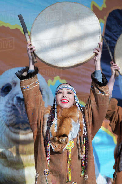 Female dancing with tambourine in national clothing indigenous ...