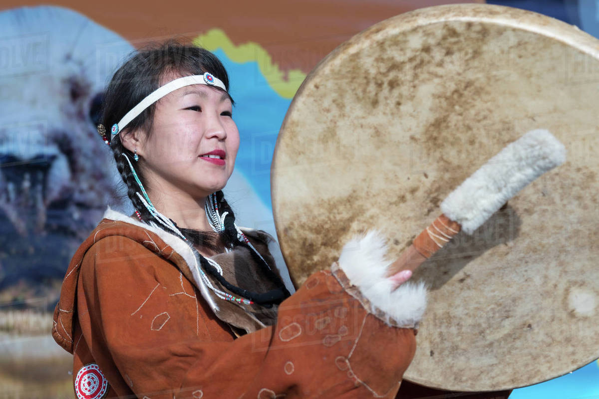 Woman dancing with tambourine in tradition clothing aborigine people ...