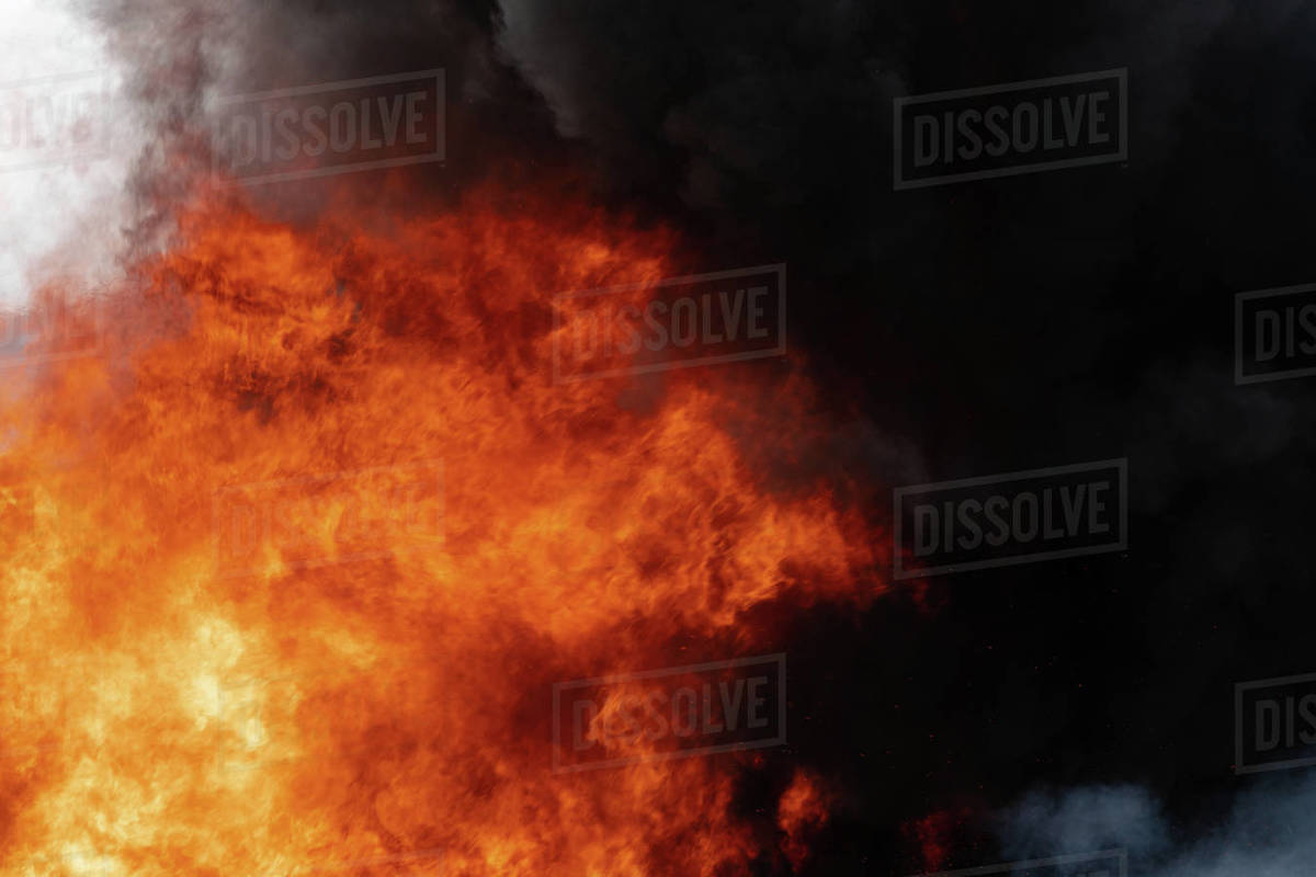 Dangerous flames of red-orange fire, motion clouds of black smoke ...