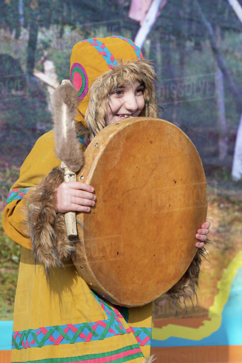 Female child dancing with tambourine in national clothing indigenous ...