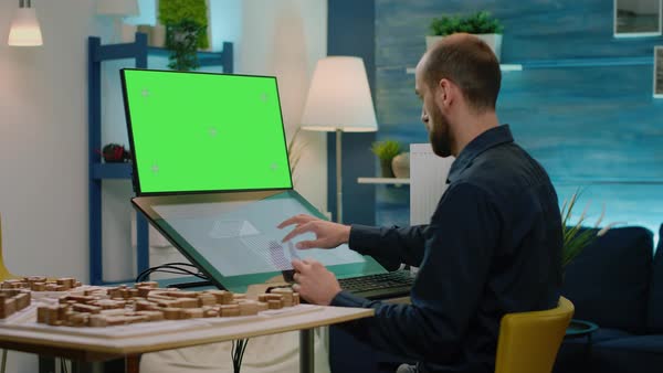 Architect using horizontal green screen and building model working on ...