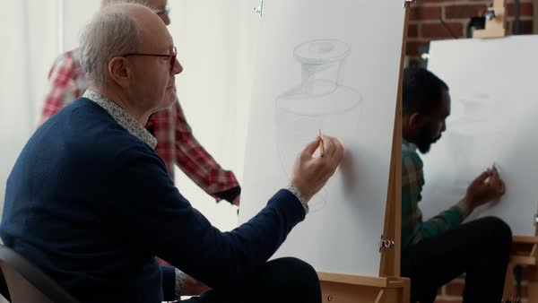Senior person attending art class program to learn drawing on canvas ...