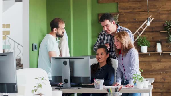 Happy young business people about their new data analysis. Coworkers ...