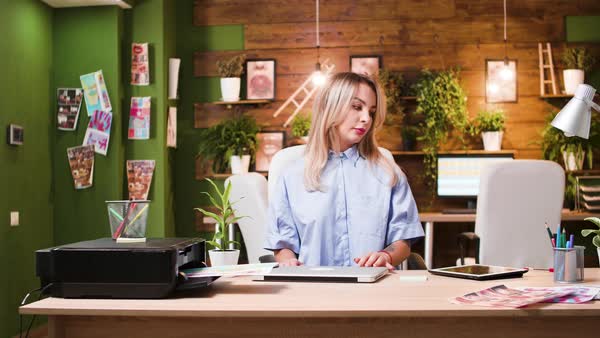 Beautiful content creator finishing the task for the day and preparing ...