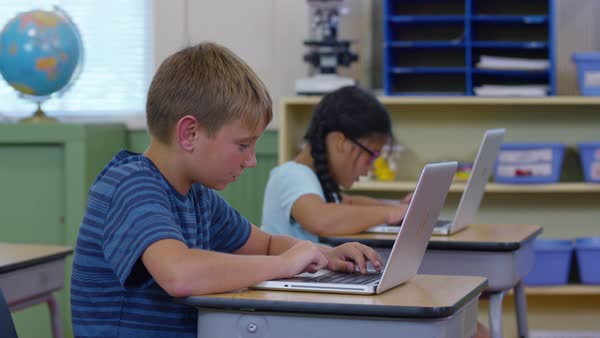 Students in school classroom working on laptop computers - 4K Royalty ...