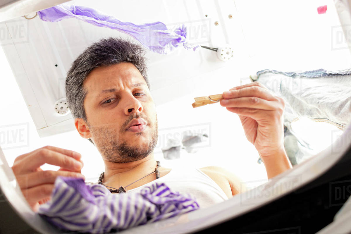 Bearded man using washing machine at home - Royalty-free Stock Photo ...